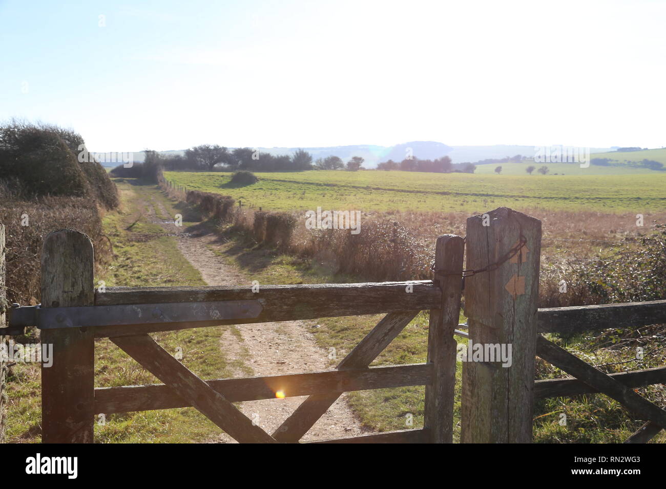 Country path with old wooden gate Stock Photo - Alamy