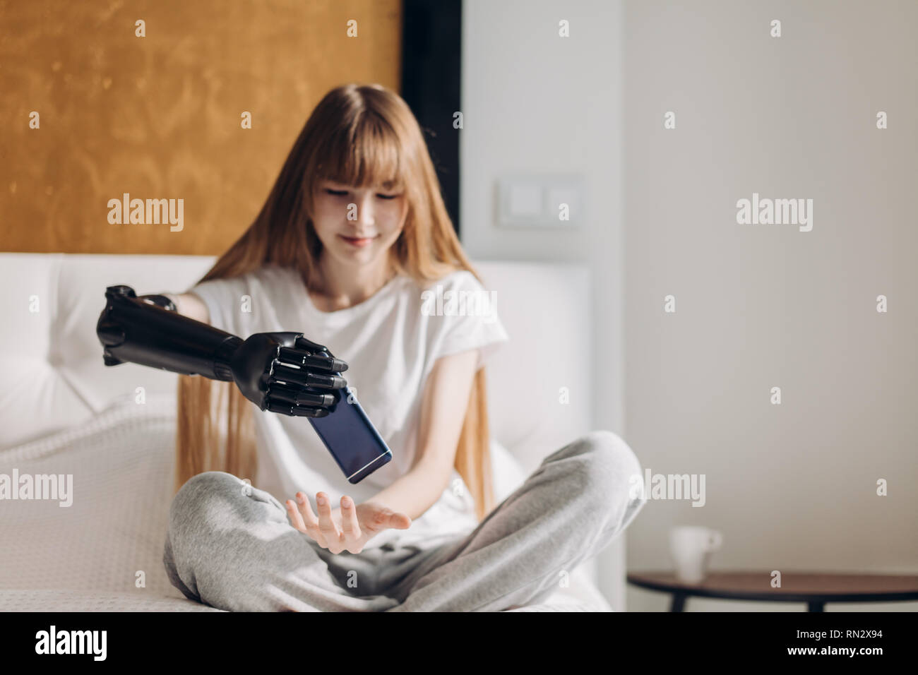 first day with a prosthetic arm. close up photo.disabled girl removes ...