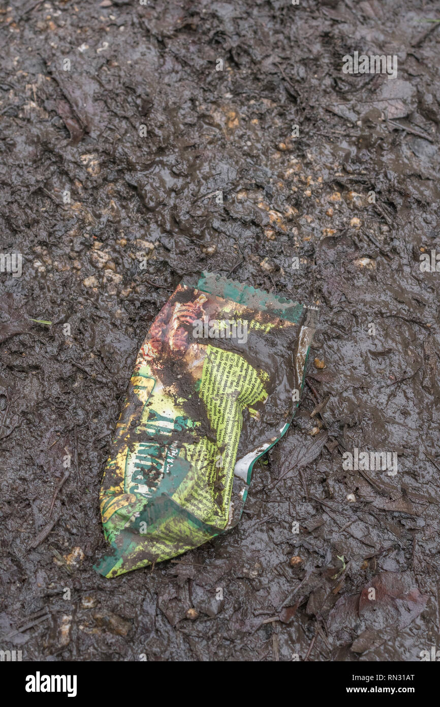 Food packaging discarded in the countryside. Plastic candy wrapper ...