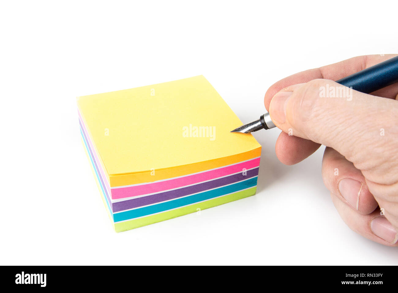 Pile of sticky note on a white background with a pen Stock Photo - Alamy