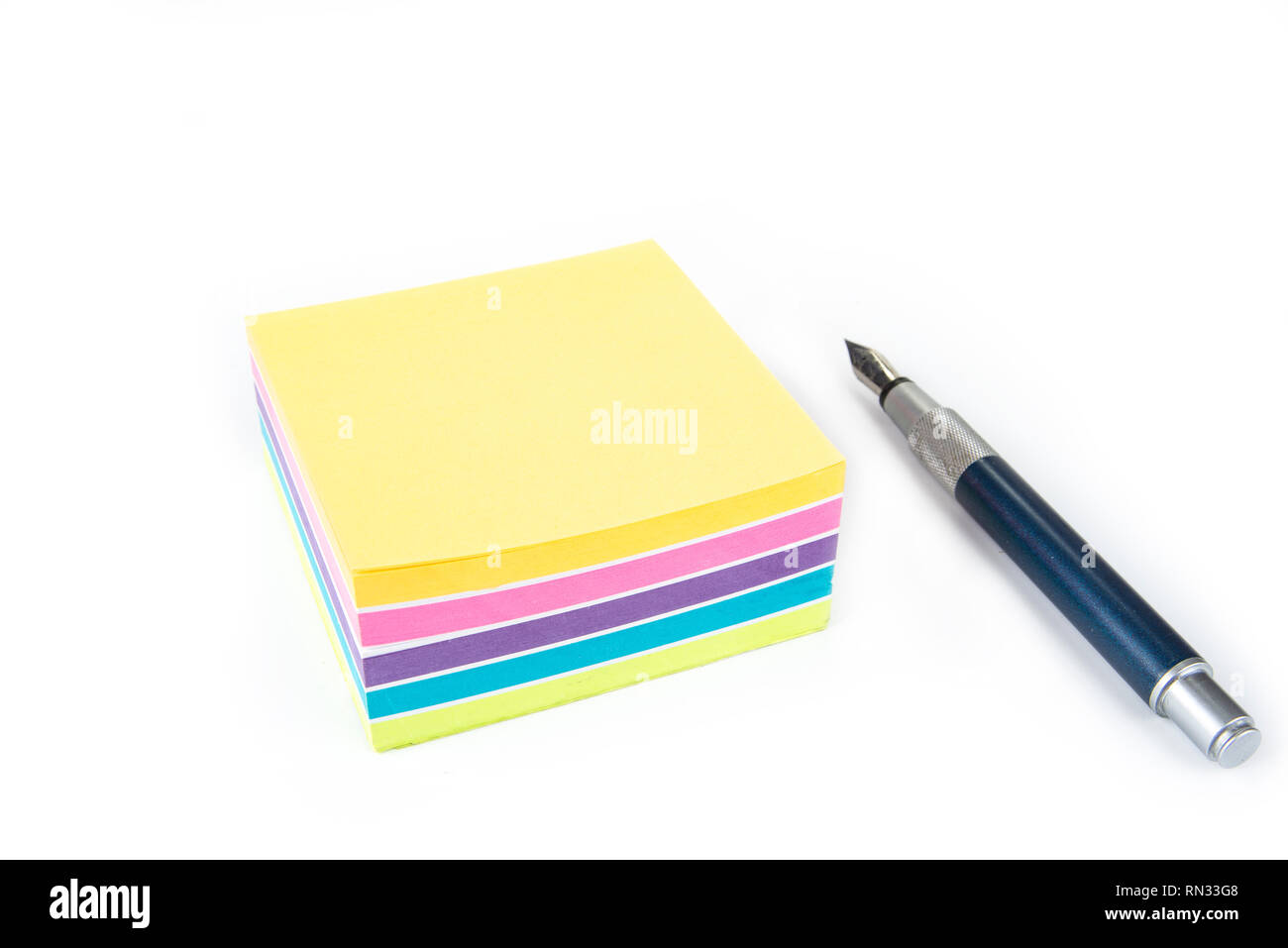 Pile of sticky note on a white background with a pen Stock Photo - Alamy