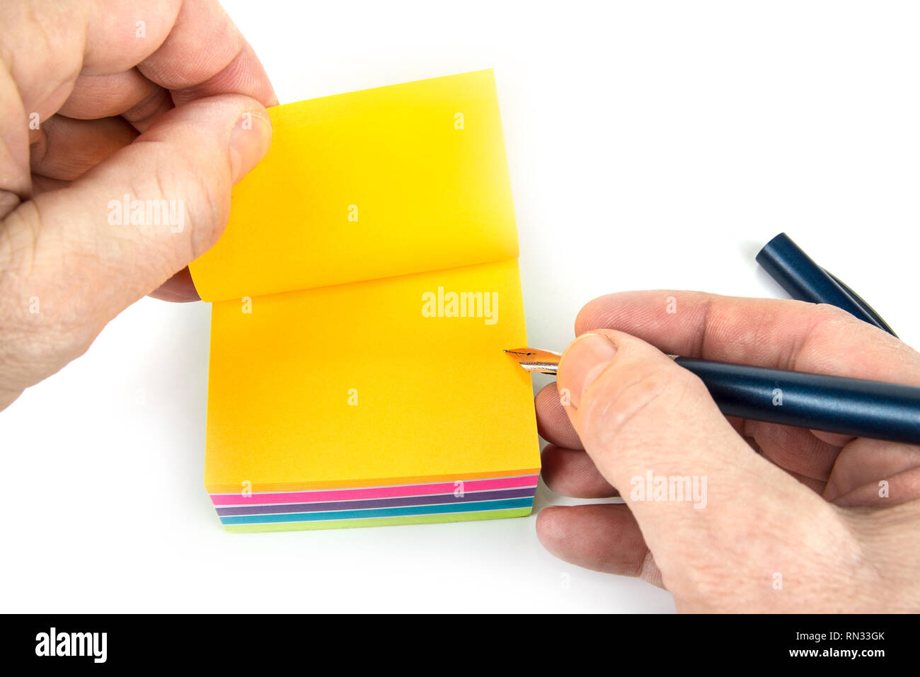 Pile of sticky note on a white background with a pen Stock Photo - Alamy