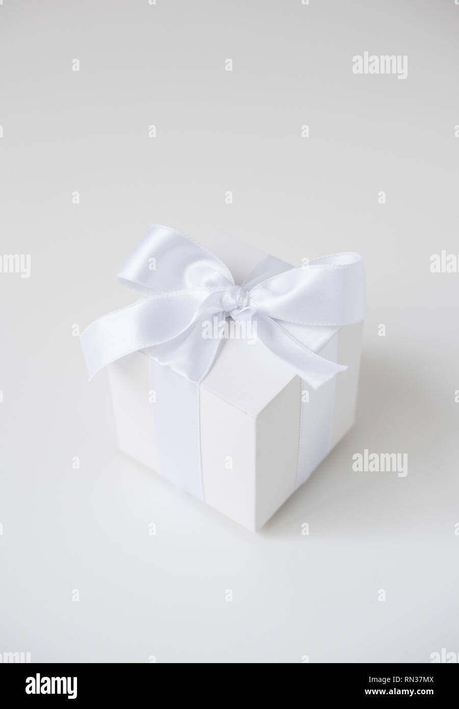 White square box with silk ribbon on white background Stock Photo - Alamy