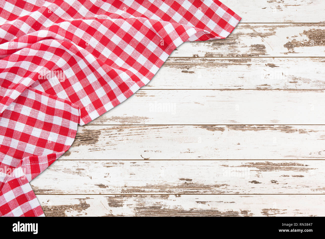 Vintage white wooden table with red checkered table cloth. Top view ...