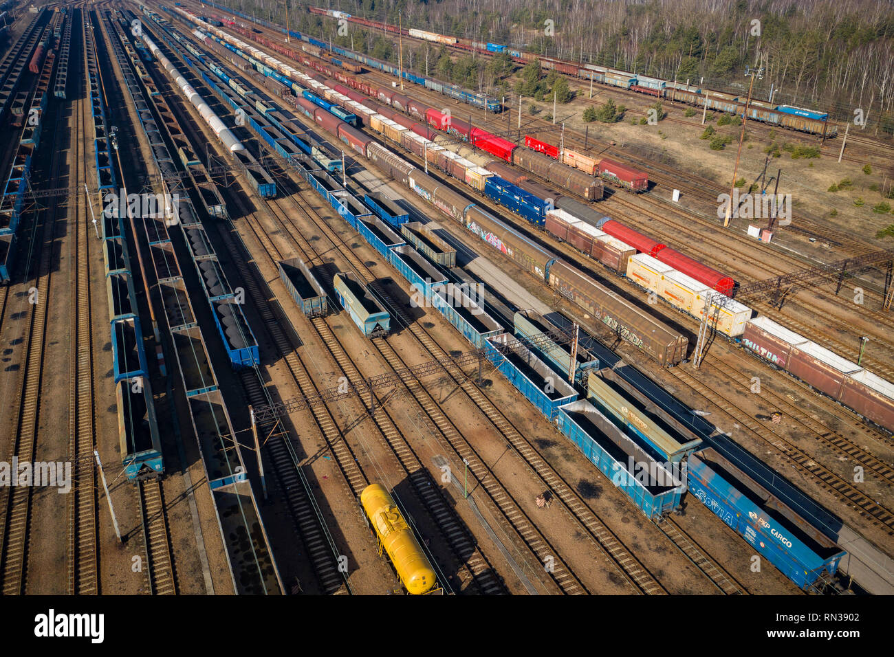 Aerial view of colorful freight trains on the railway station. Wagons ...