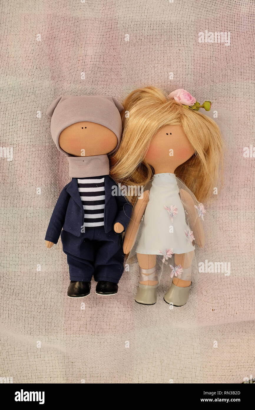Married couple dolls on the background of a light fabric background ...