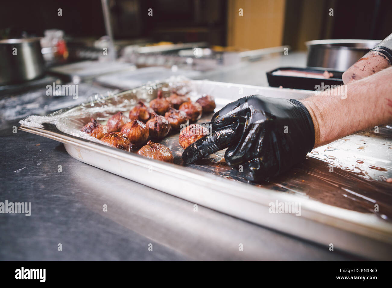 Theme cooking. Hands close up. young Caucasian man in black uniform and ...
