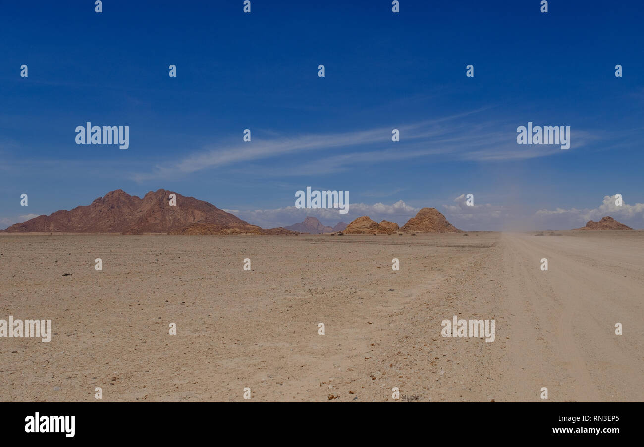 Driving on an unpaved road in the western area of Namibia, Africa Stock ...