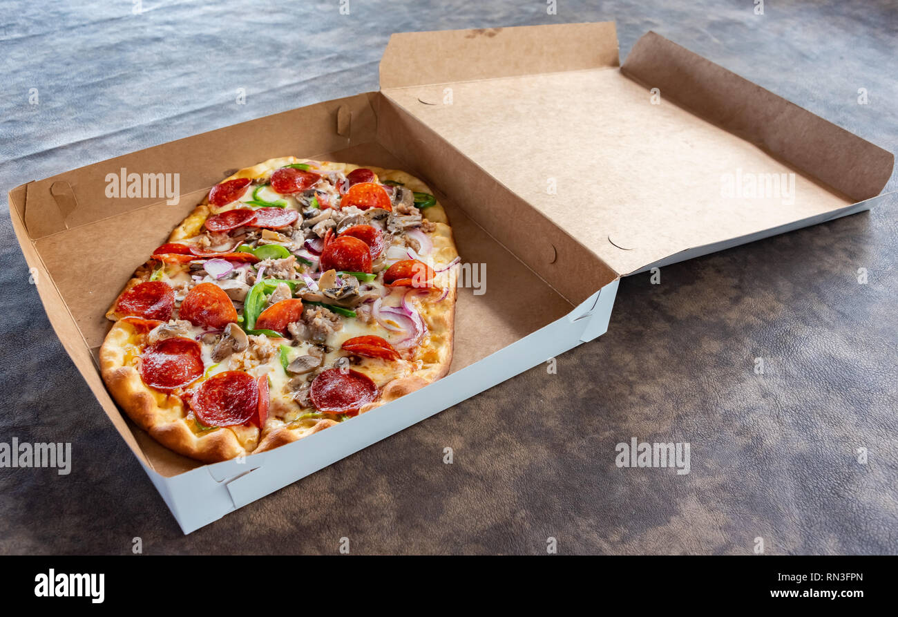 Pizza with several toppings in delivery box Stock Photo - Alamy