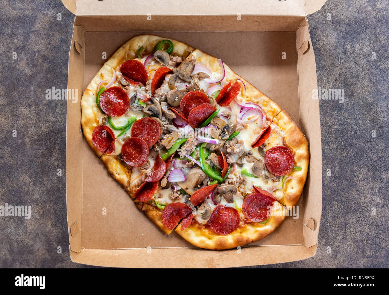 Pizza with several toppings in delivery box Stock Photo - Alamy