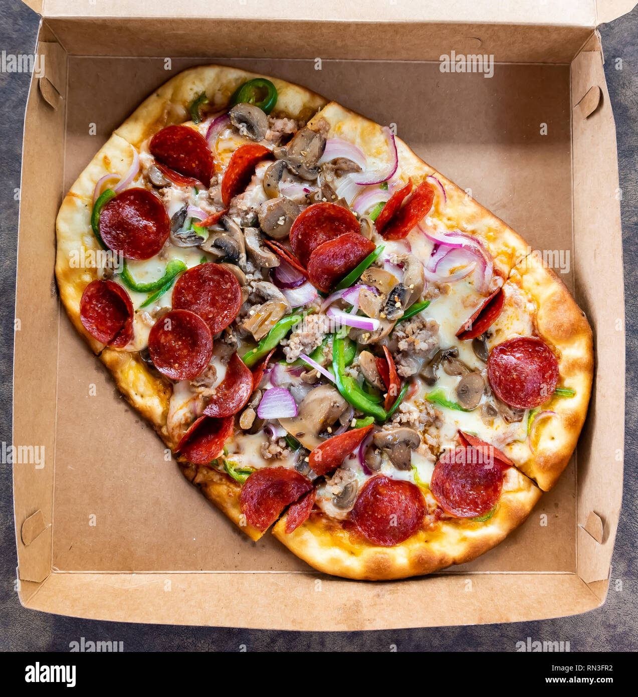 Pizza with several toppings in delivery box Stock Photo - Alamy