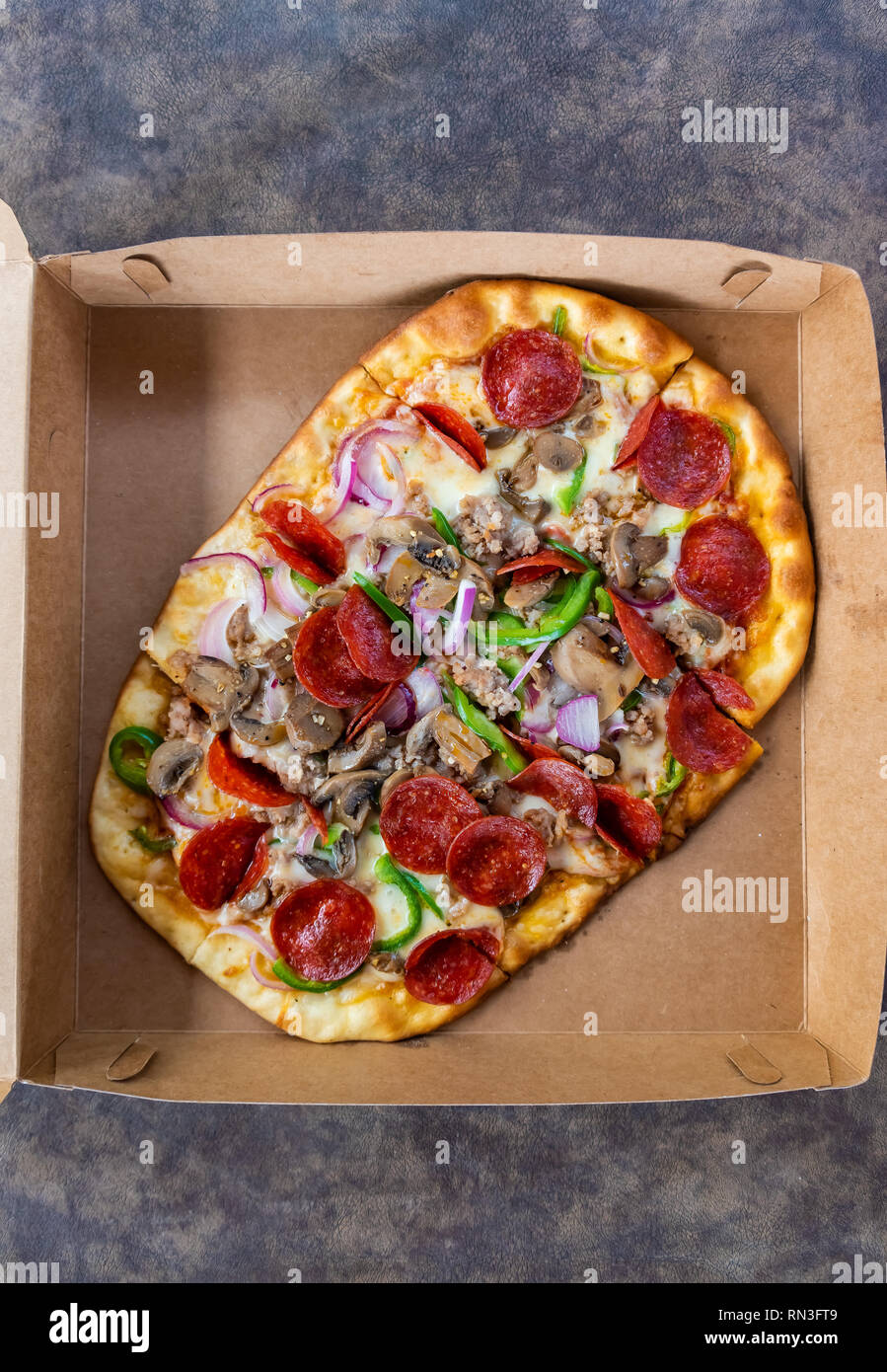 Pizza with several toppings in delivery box Stock Photo - Alamy