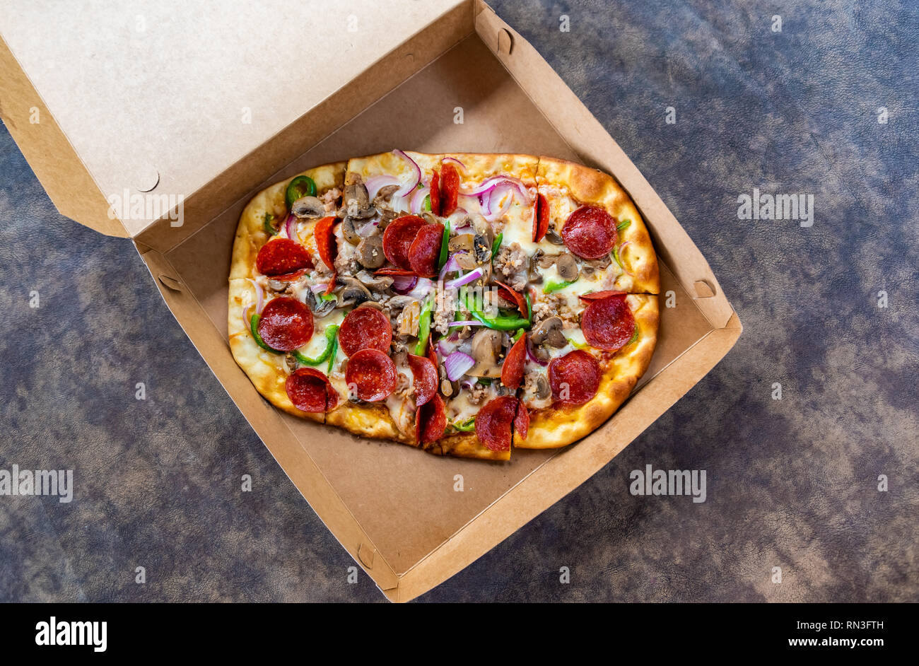 Pizza with several toppings in delivery box Stock Photo - Alamy
