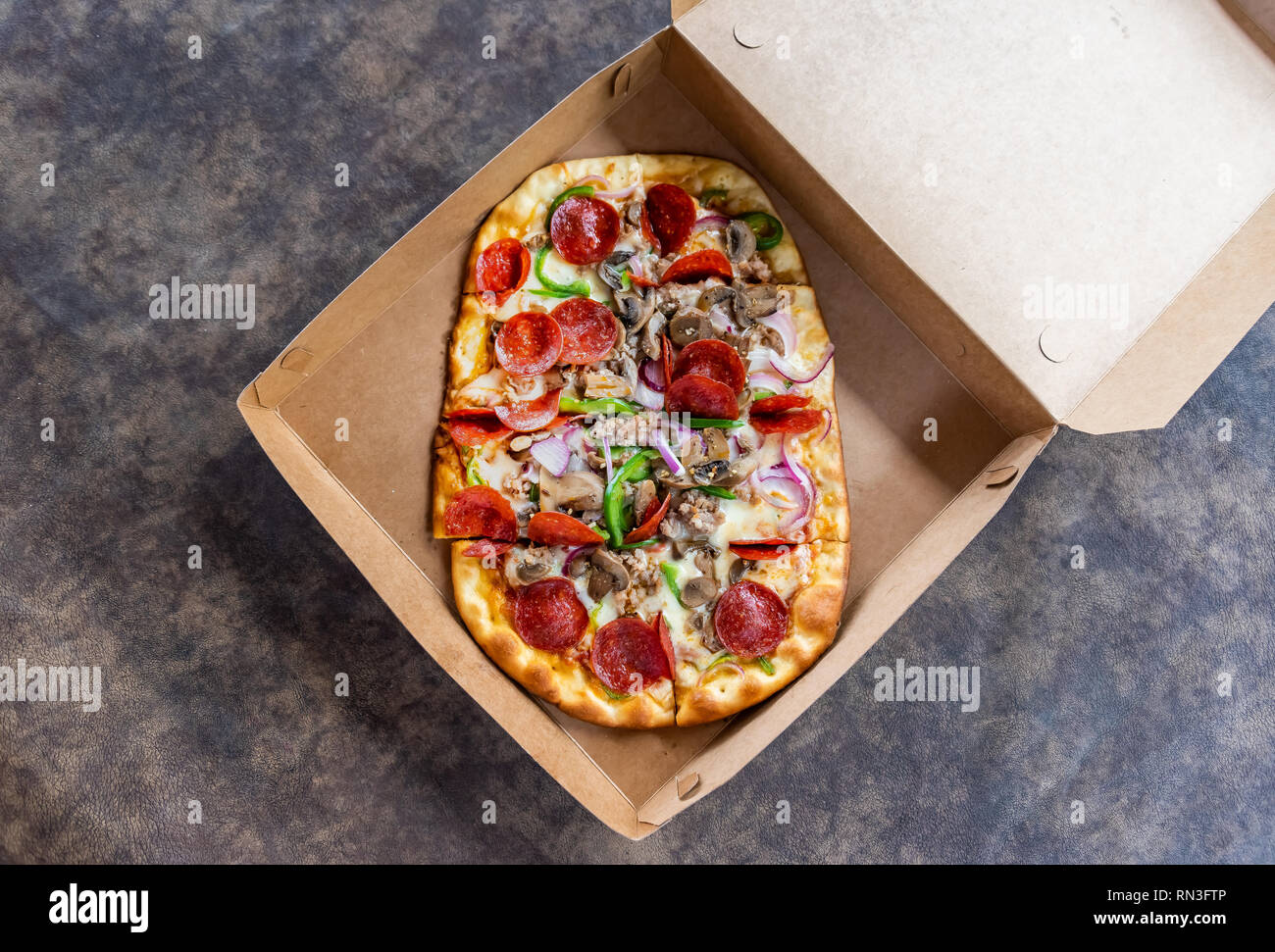 Pizza with several toppings in delivery box Stock Photo - Alamy