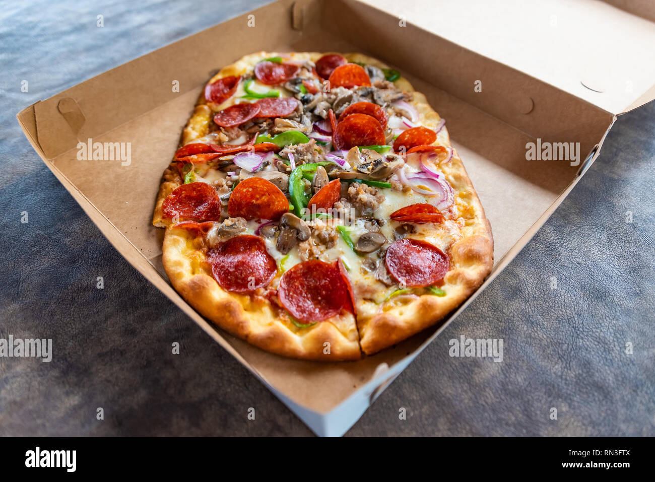 Pizza with several toppings in delivery box Stock Photo - Alamy