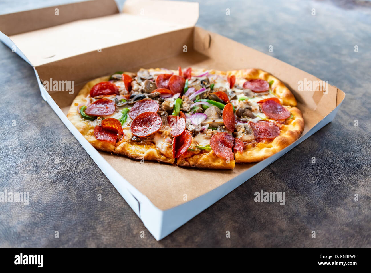 Pizza with several toppings in delivery box Stock Photo - Alamy