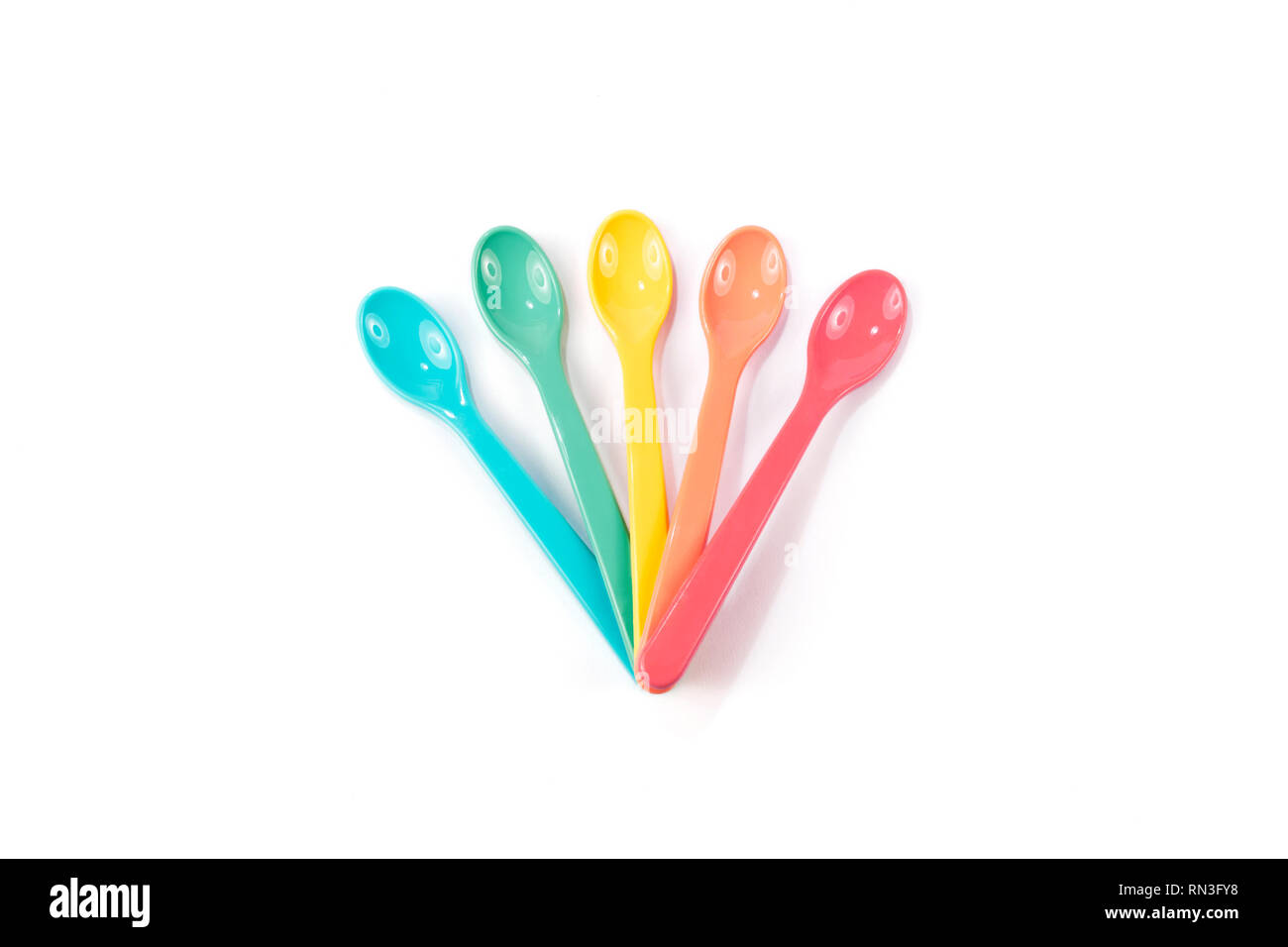 Colorful bunch of plastic baby spoons on white background - happy food ...