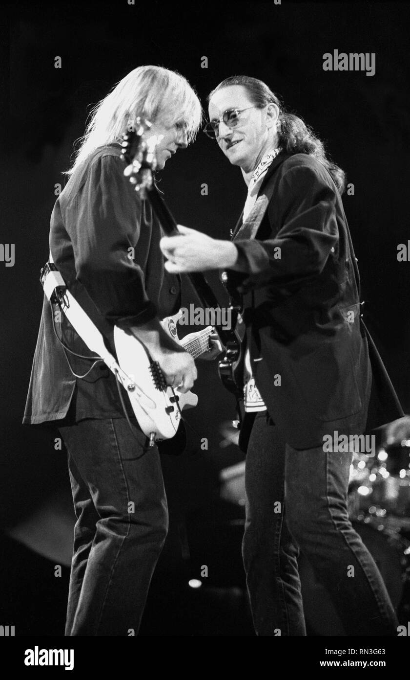 Musicians Alex Lifeson and Geddy Lee are shown performing on stage ...