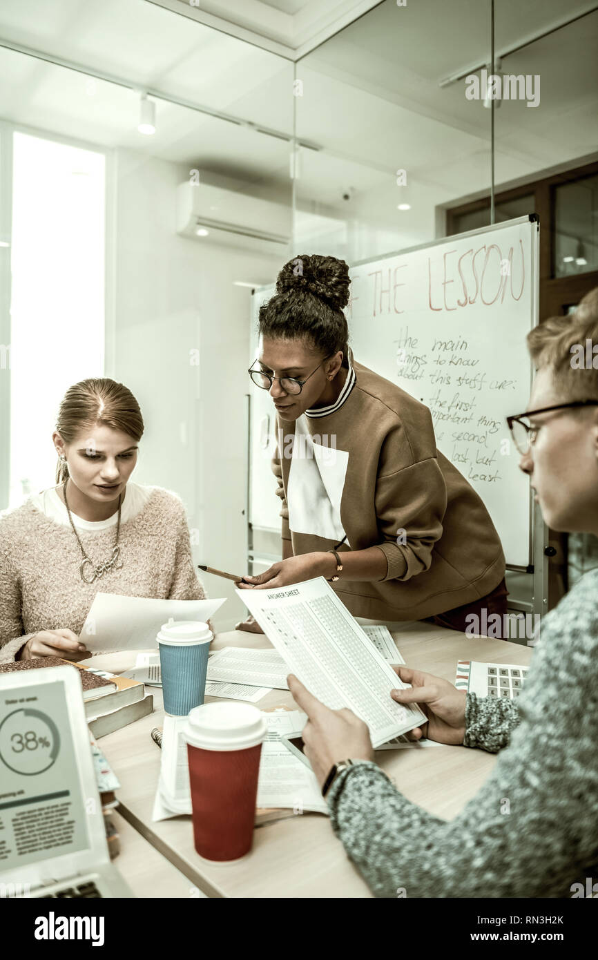 Two students listening to their teacher attentively during the class ...
