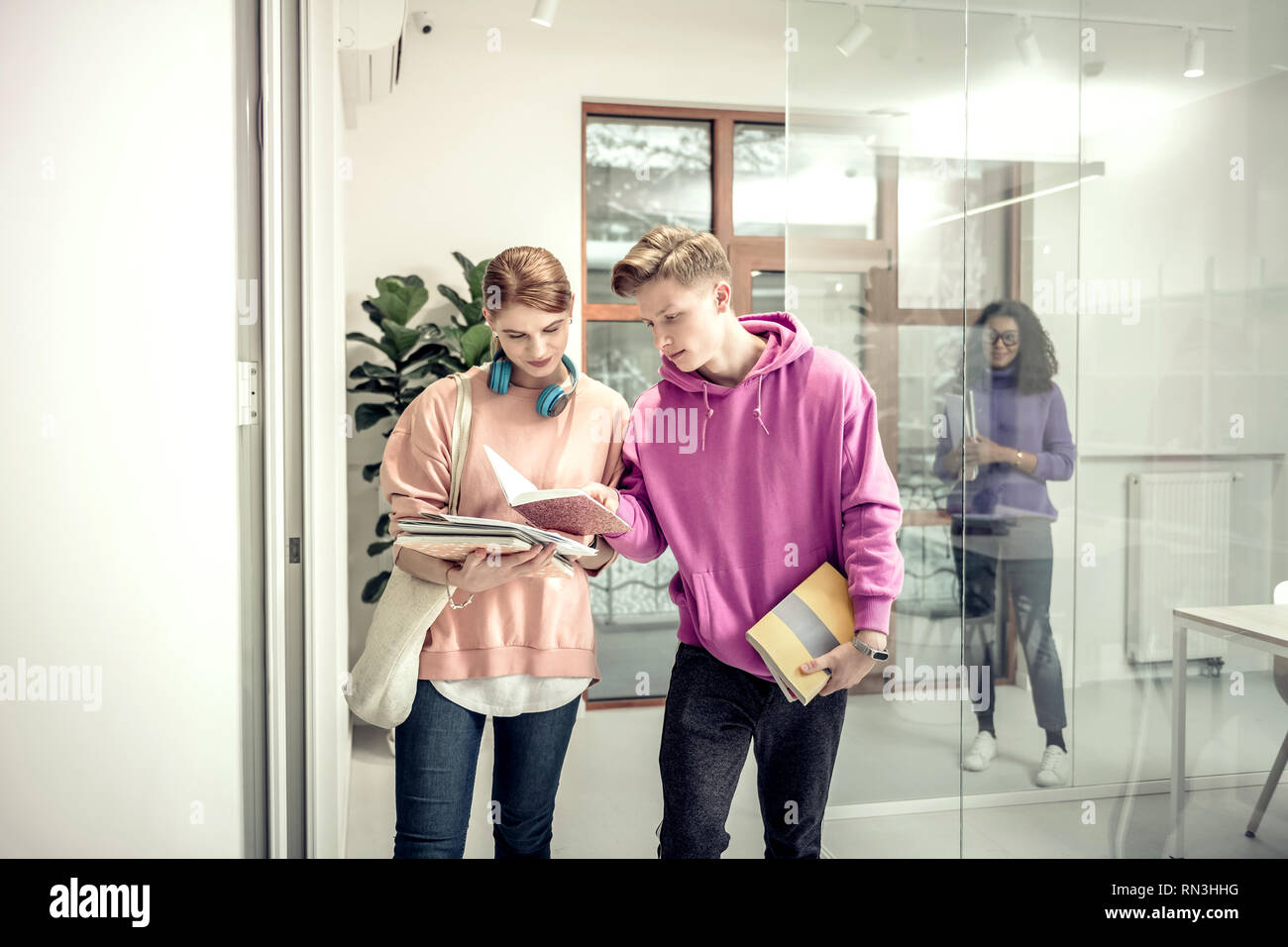 Couple of students walking to class together discussing the test Stock ...