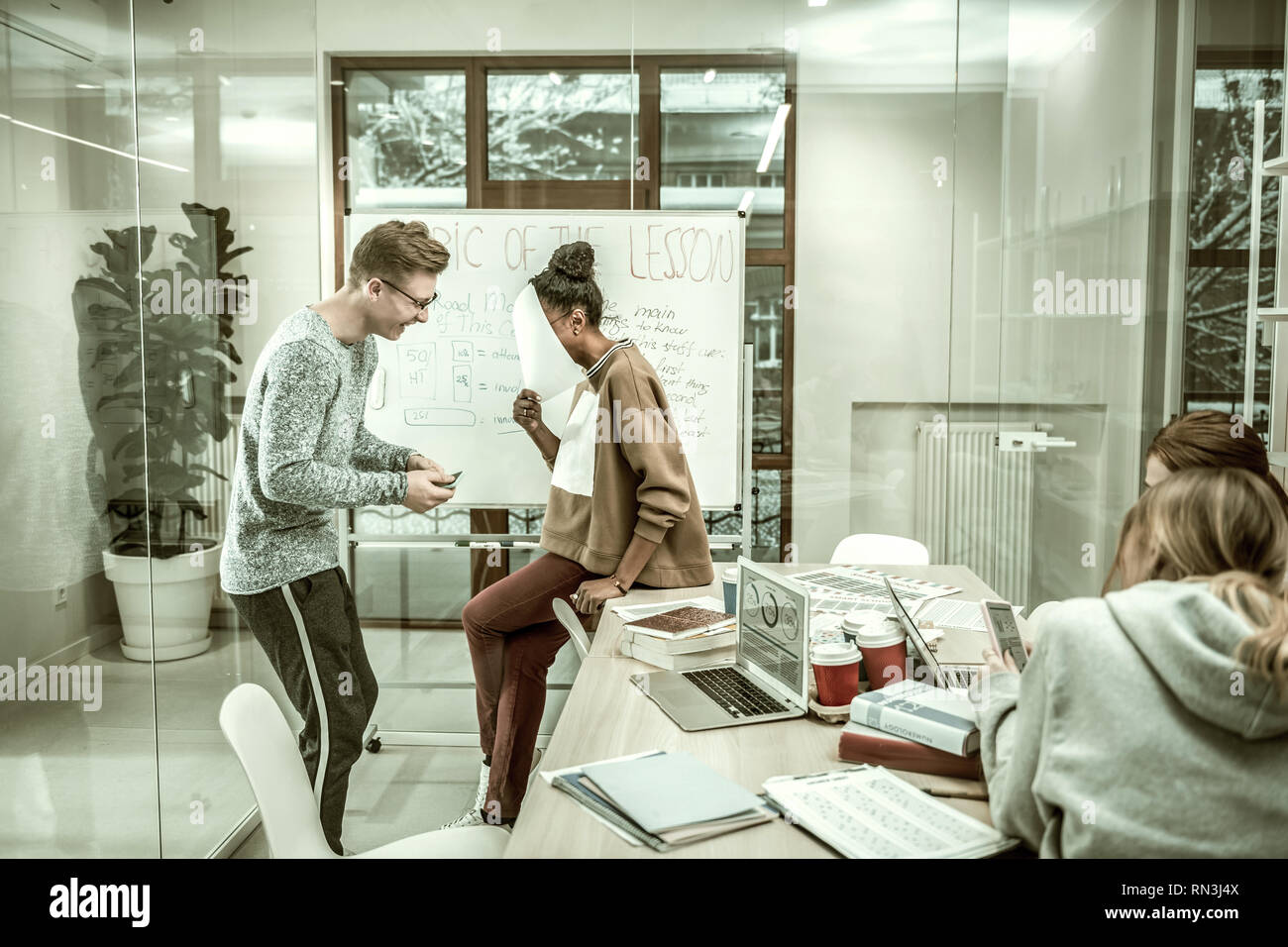 Student and teacher laughing after funny moment at the class Stock ...