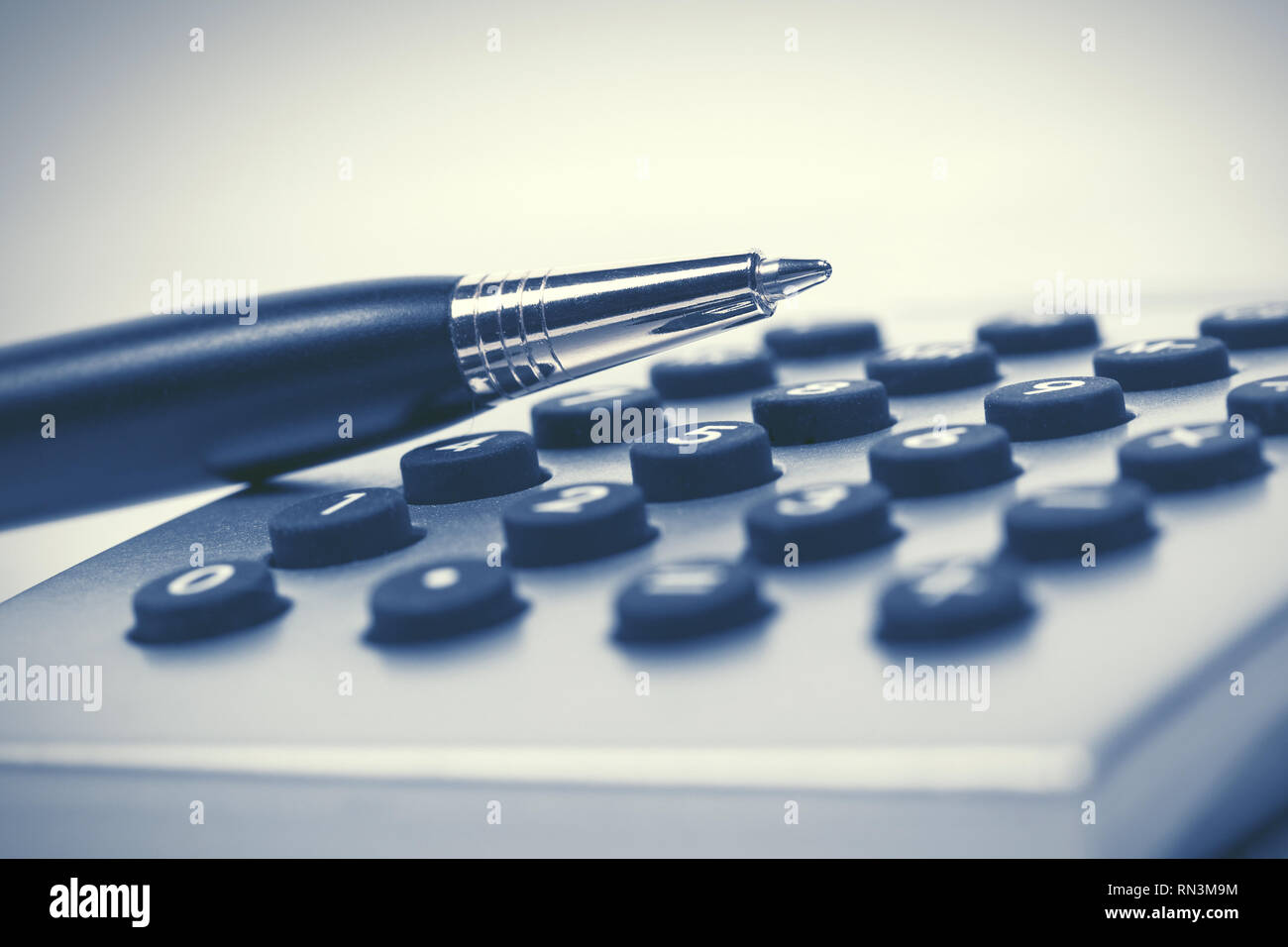 Financial accounting pen on calculator Stock Photo - Alamy