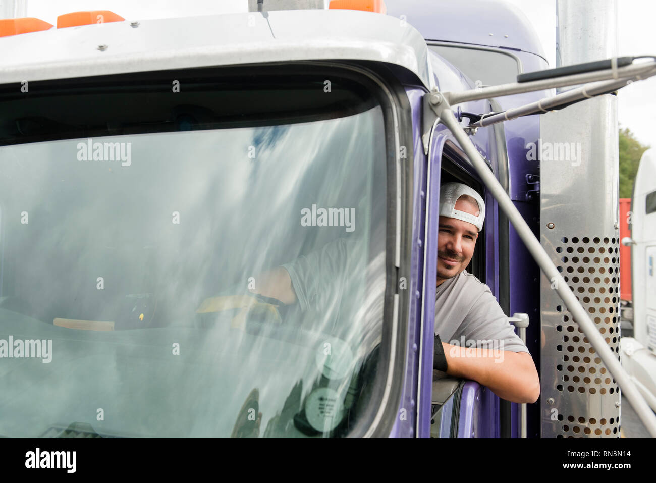 Man driving semi-truck Stock Photo - Alamy