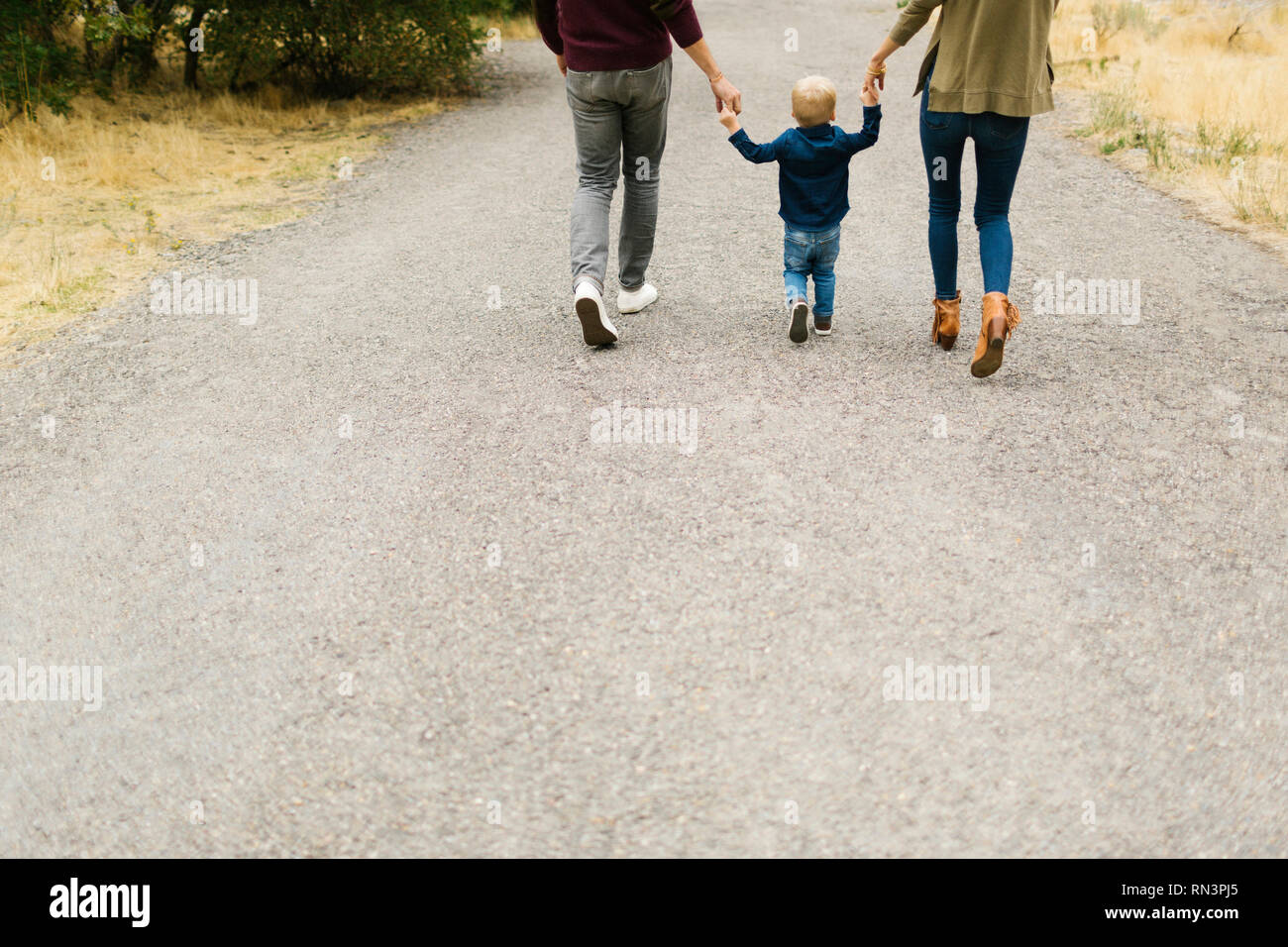 Family walking on rural road together Stock Photo - Alamy