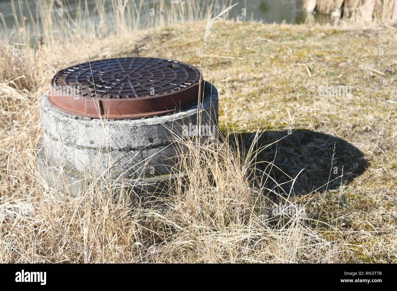 manhole cover standing up in the grassland Stock Photo - Alamy