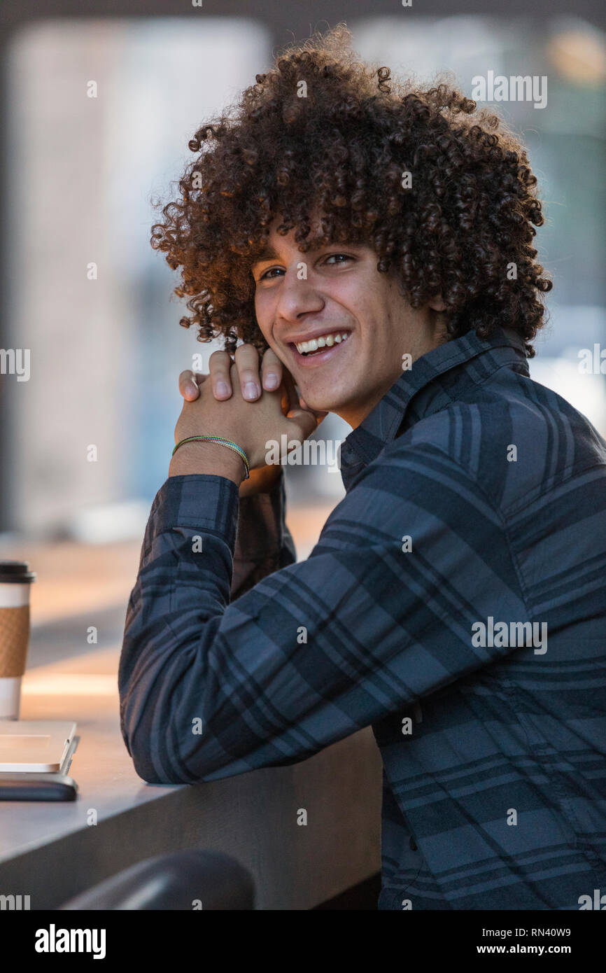 Smiling teenage boy in cafe Stock Photo - Alamy