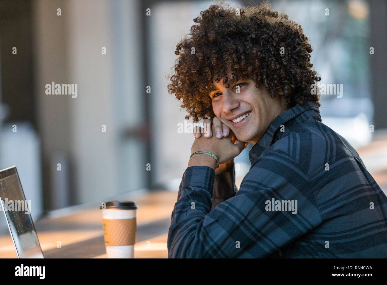 Smiling teenage boy in cafe Stock Photo - Alamy