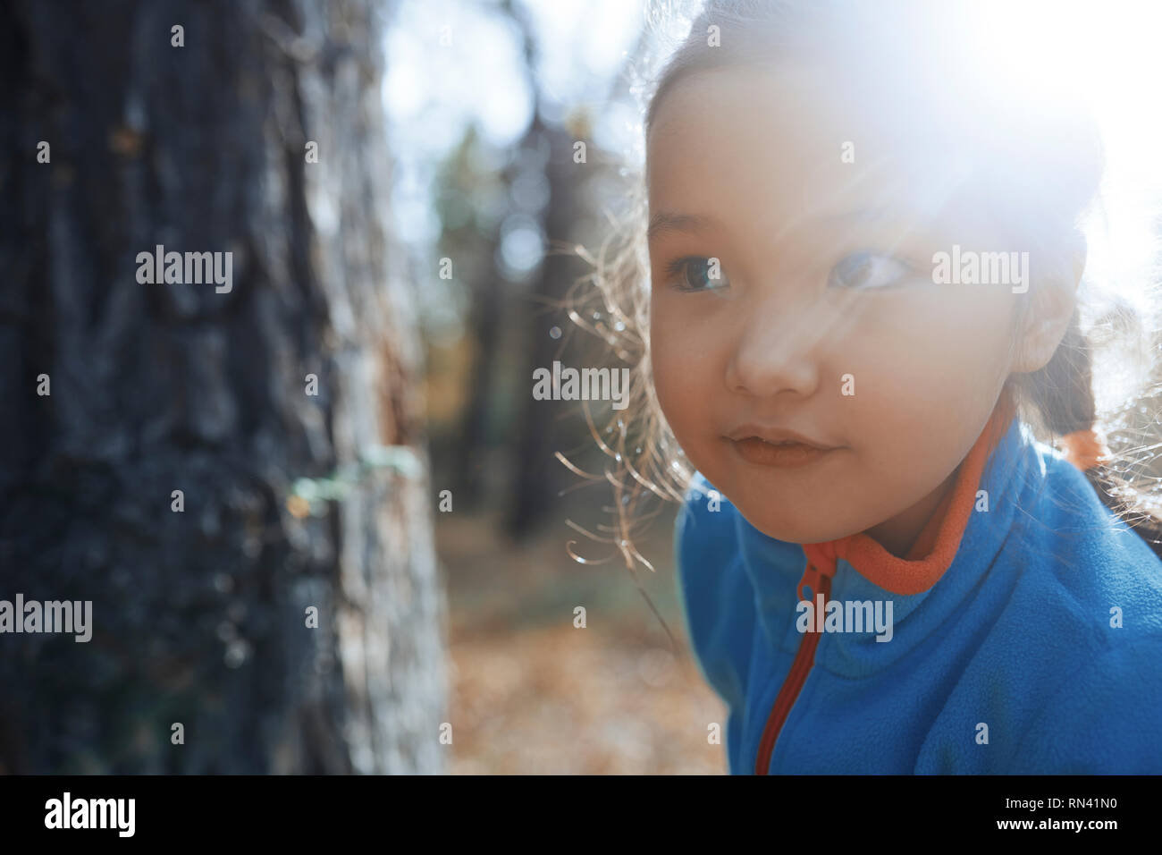 Girl under sunshine in forest Stock Photo - Alamy