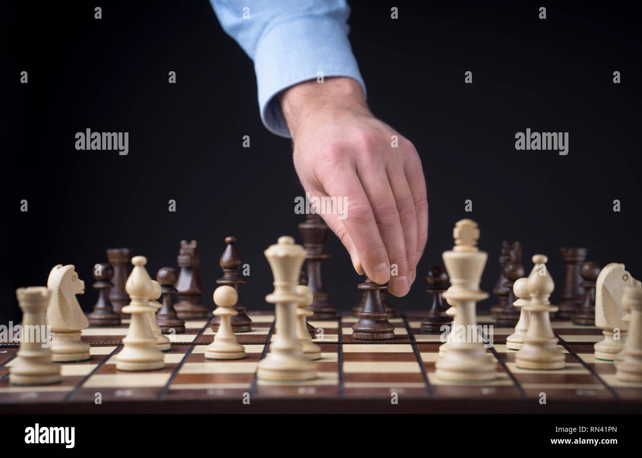 Hand of man playing chess Stock Photo - Alamy
