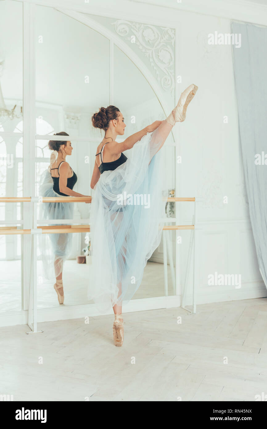 Young classical ballet dancer woman in dance class. Beautiful graceful ballerina practice ballet ...