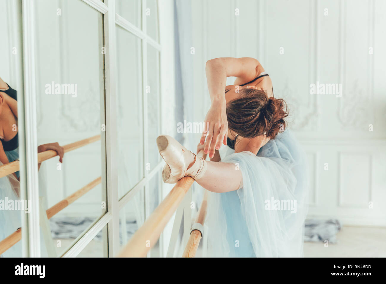 Young classical ballet dancer woman in dance class. Beautiful graceful ballerina practice ballet ...