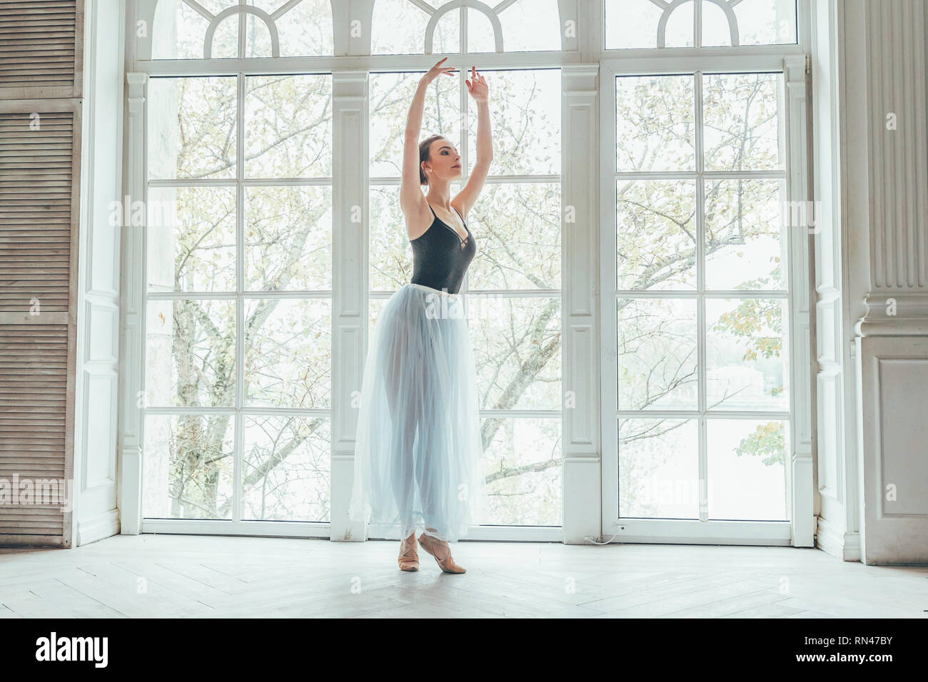 Young classical ballet dancer woman in dance class. Beautiful graceful ballerina practice ballet ...