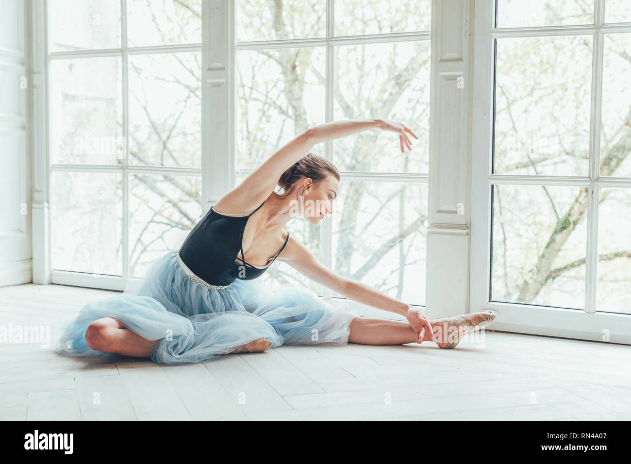 Young classical ballet dancer woman in dance class. Beautiful graceful ballerina practice ballet ...