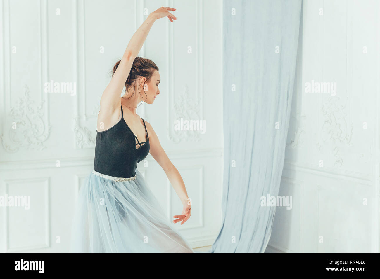 Young classical ballet dancer woman in dance class. Beautiful graceful ballerina practice ballet ...