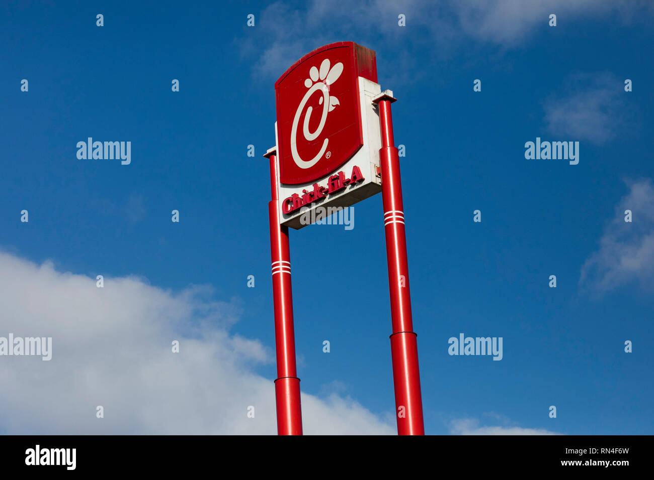 A logo sign outside of a Chick-fil-A restaurant location in Martinsburg ...