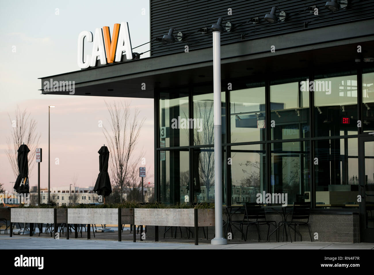 A logo sign outside of a Cava restaurant location in Chantilly ...