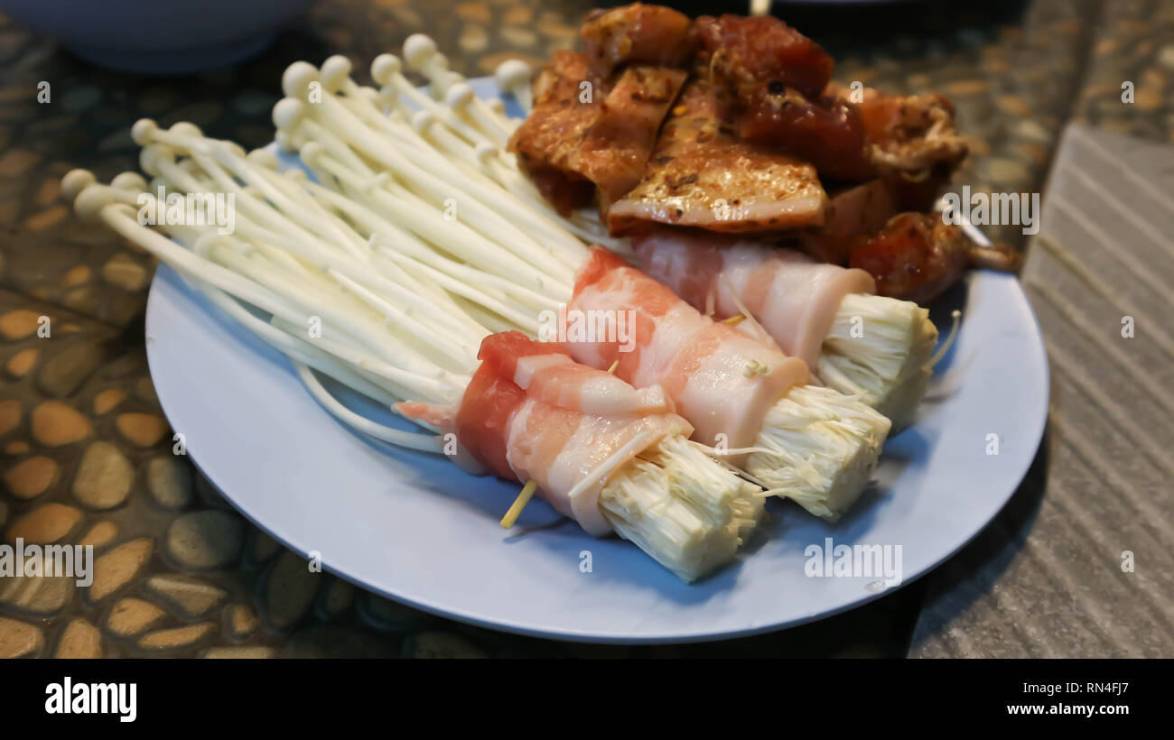 bacon wrapped enoki or bacon wrapped mushroom and pork Stock Photo - Alamy