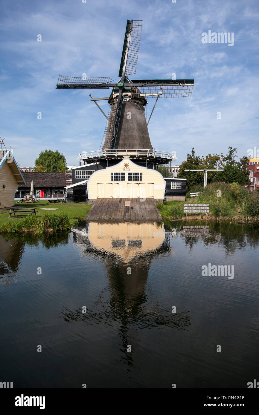 Windmill and mirrored in the water in front Stock Photo - Alamy