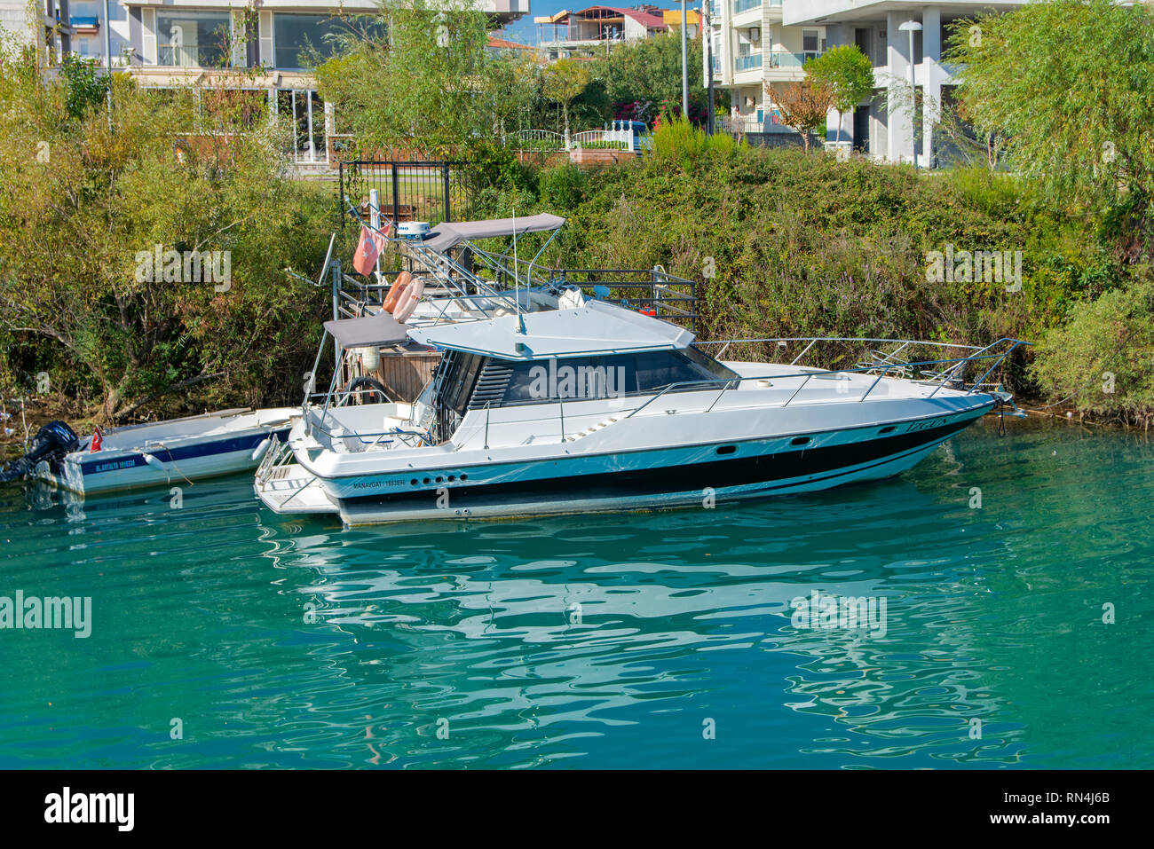 Alanya, Turkey - October 05, 2018. A small speedboat moored at the pier ...