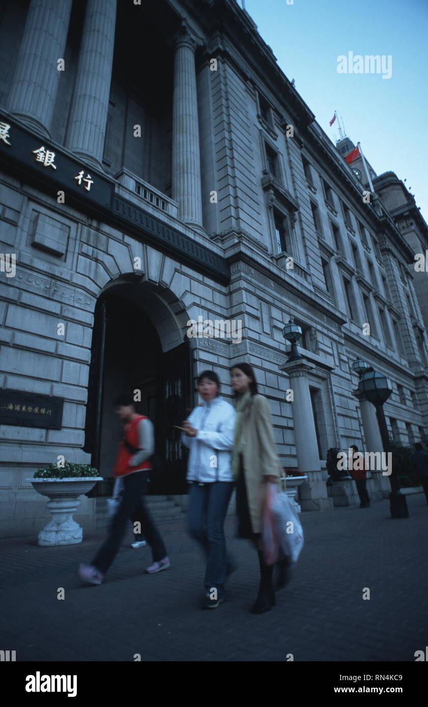 Caption: Shanghai, China - Nov 2002. Shoppers walking past one of the ...