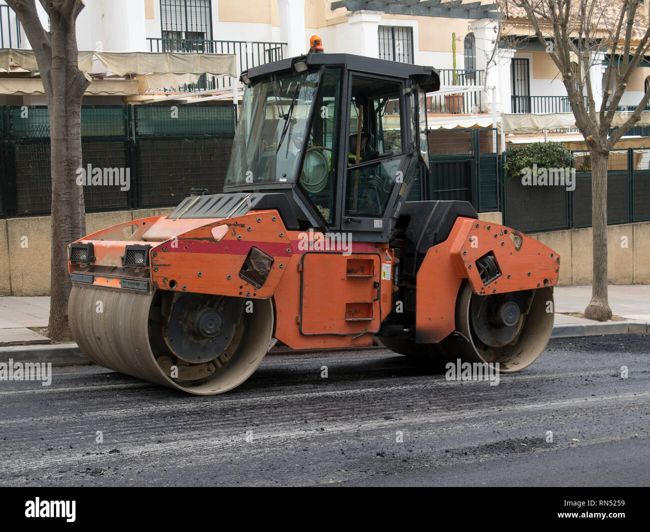 Modern heavy asphalt roller stacking and press hot asphalt. Orange road ...