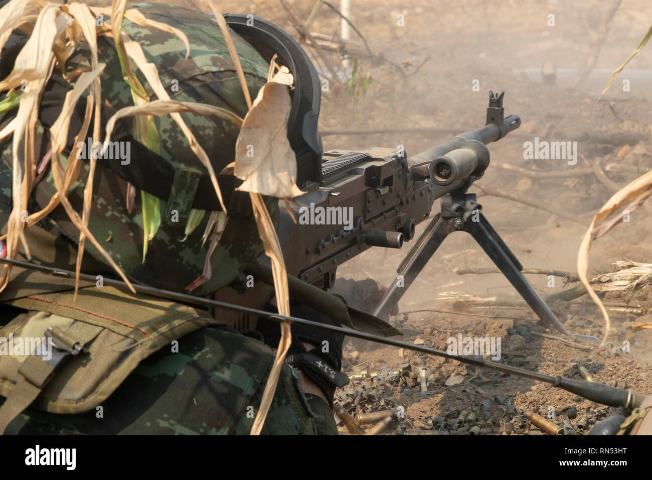 A Royal Thai Army soldier fires an M240 Machine Gun at an enemy target ...