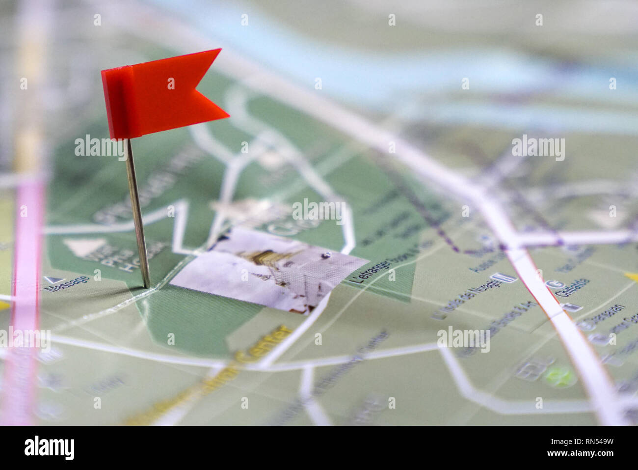 Travel concept: a red flag pushpin on a location of a destination point ...