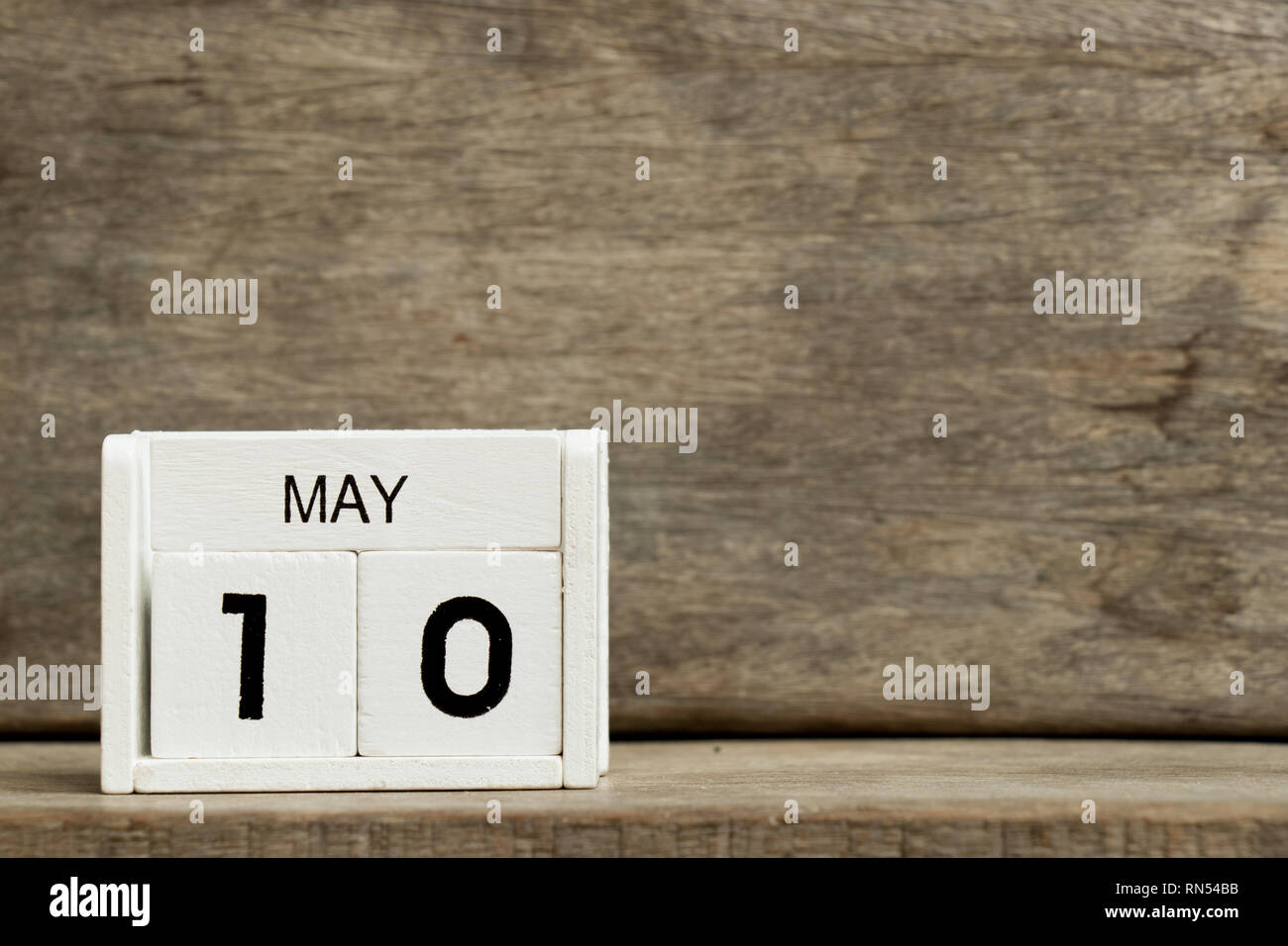 White block calendar present date 10 and month May on wood background ...