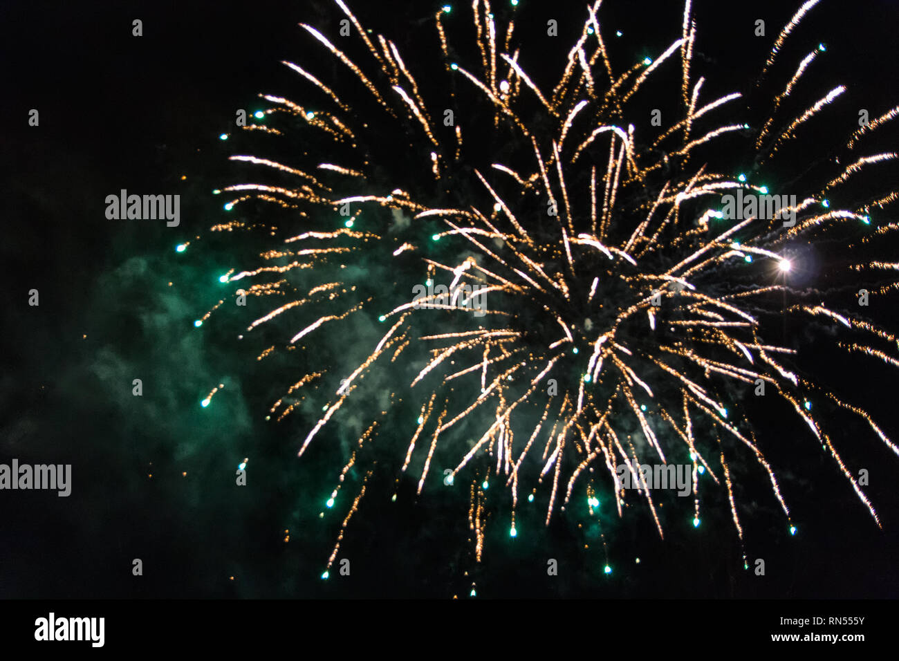 Amazing orange fireworks on dark sky with green smoke Stock Photo - Alamy