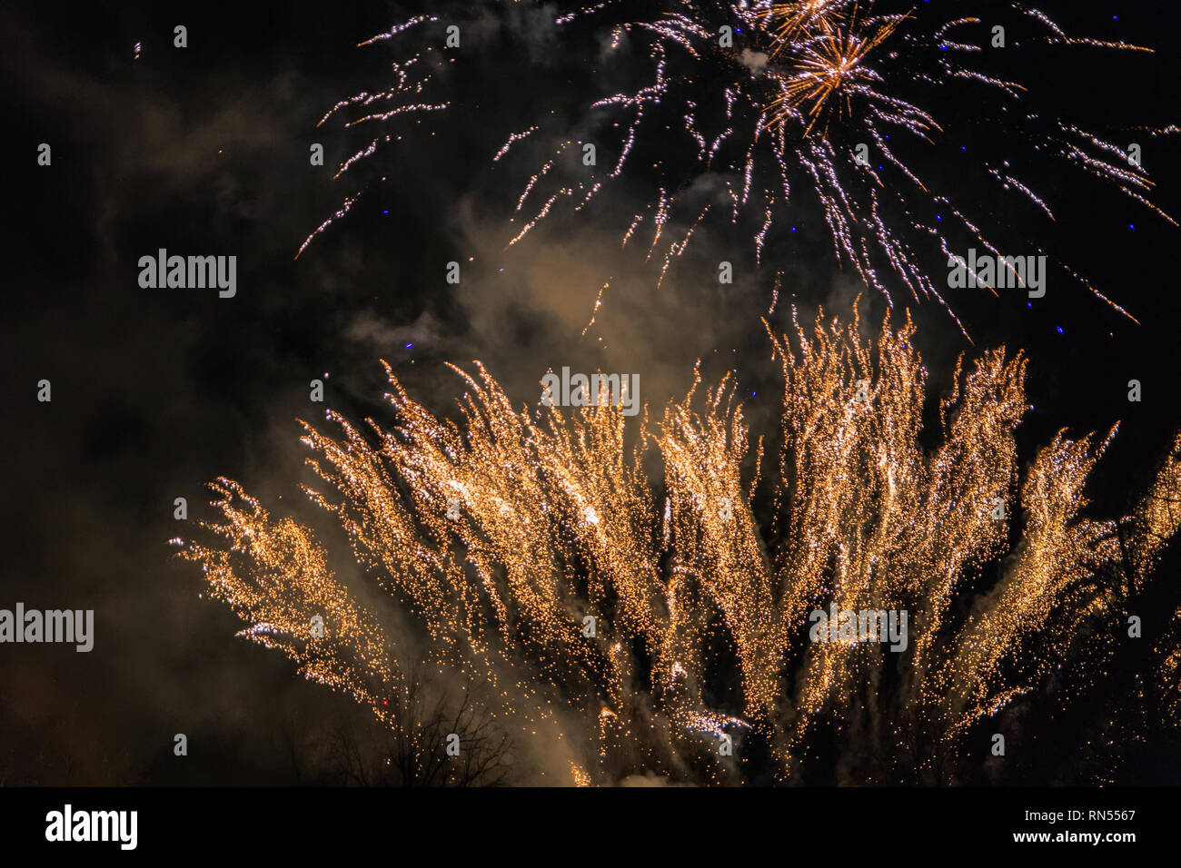 Amazing orange fireworks on dark sky with smoke Stock Photo - Alamy